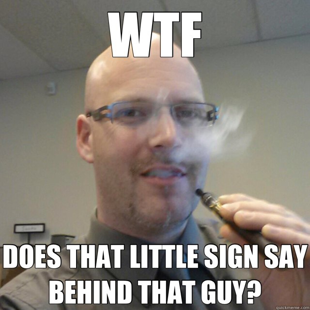 WTF DOES THAT LITTLE SIGN SAY BEHIND THAT GUY? - Misc - quickmeme